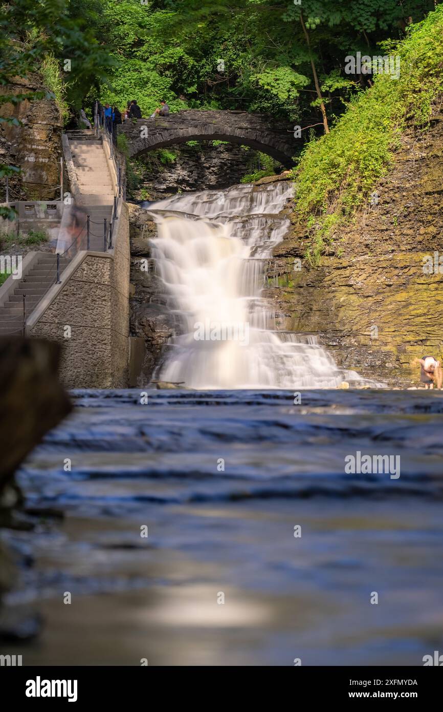 Vertical photo of a waterfall with a trail / concrete stairs ...