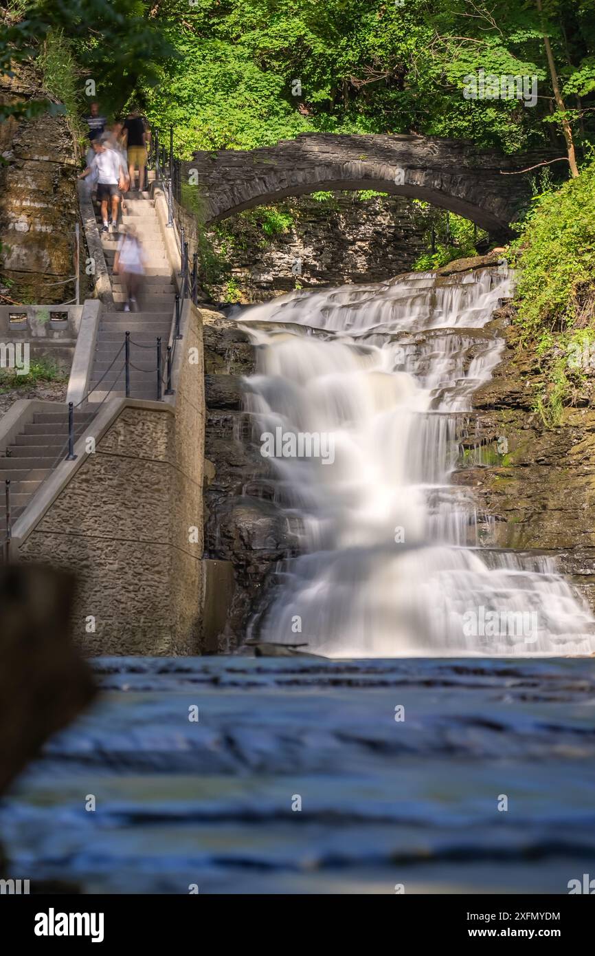 Vertical photo of a waterfall with a trail / concrete stairs ...