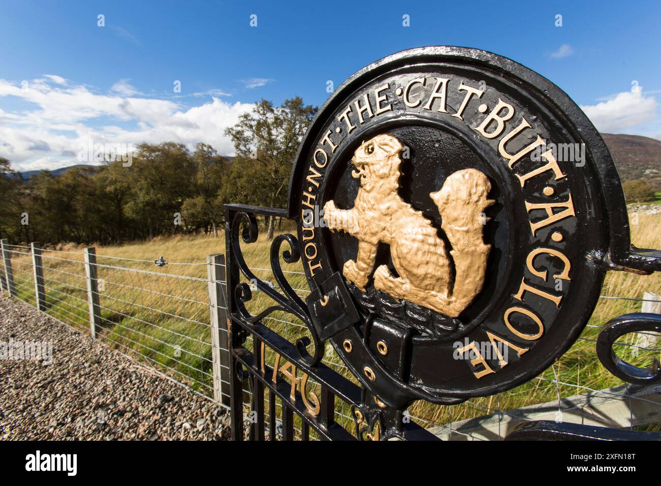 MacPherson clan motto on gate, with reference to Scottish wildcat ...