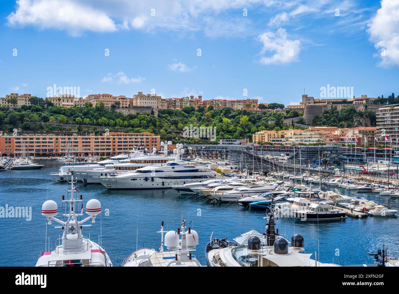 Luxury yachts moored in Port Hercule marina, with the old town and ...