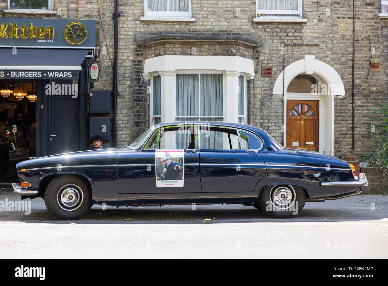 London, UK. 04, JUL, 2024. Vintage car branded with Jeremy Corbyn's ...
