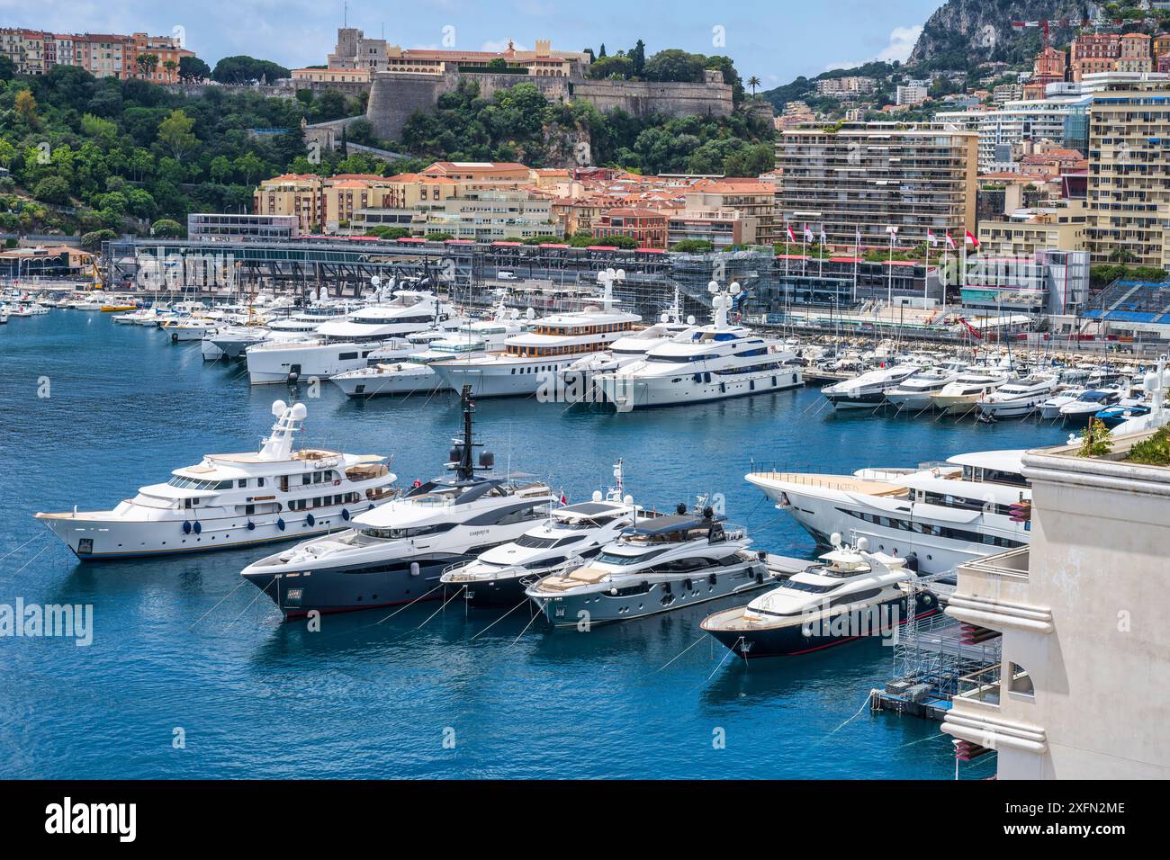 Luxury yachts moored in Port Hercule marina, with the old town and ...