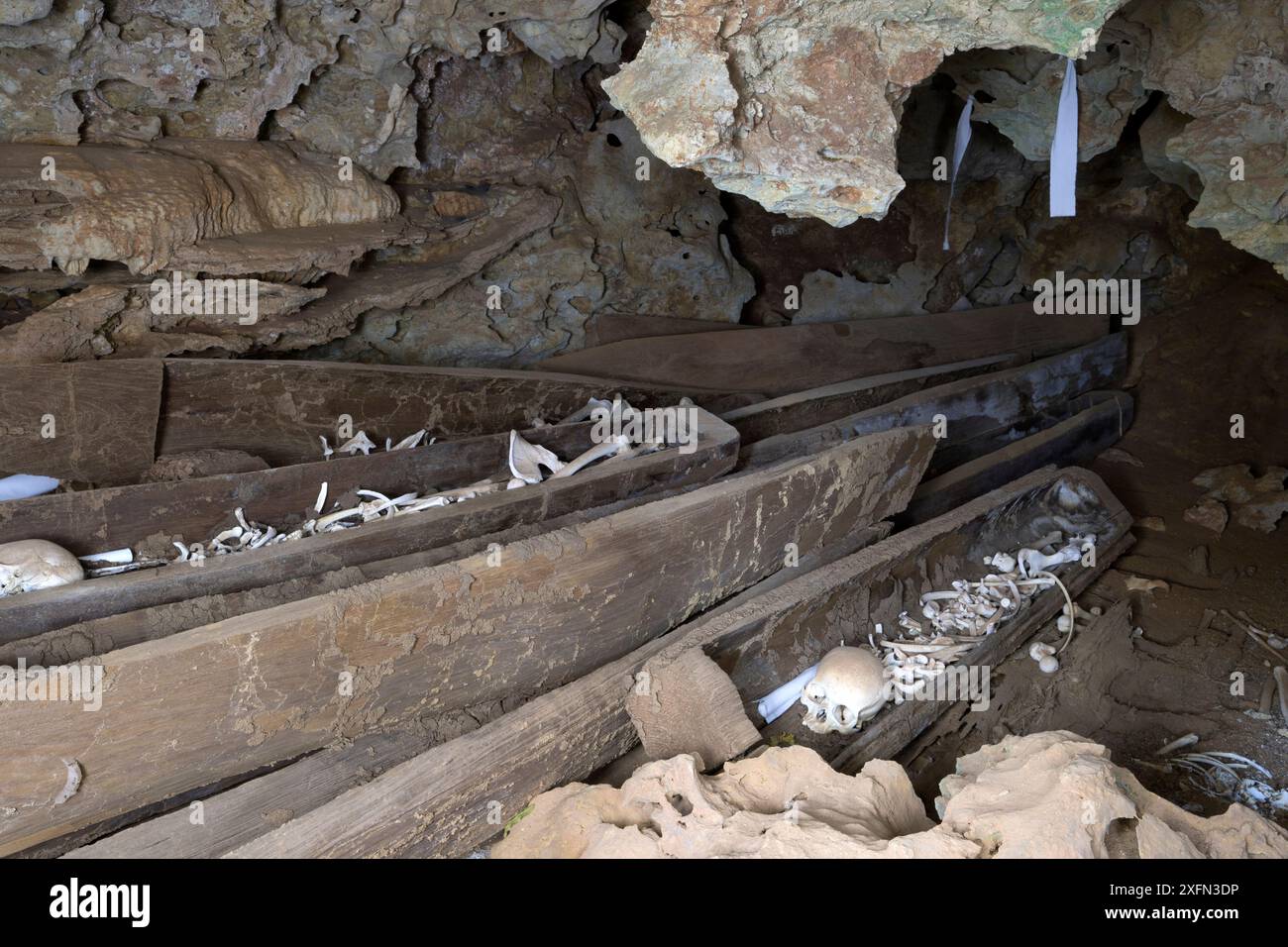 Human skulls and bones in wooden troughs, traditional burial site from ...