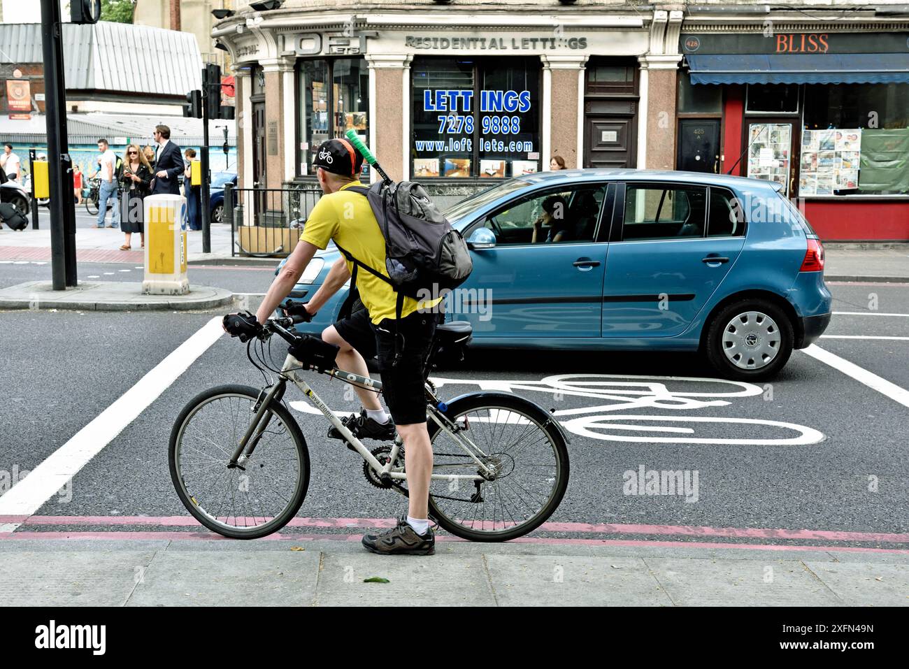 Commuter cyclist in advanced stop lane alongside illegally positioned ...