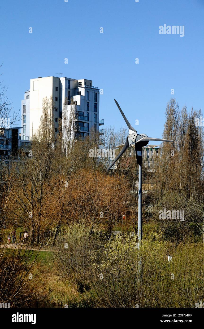 Wind turbine in urban setting with flats behind, Mile End Park London ...
