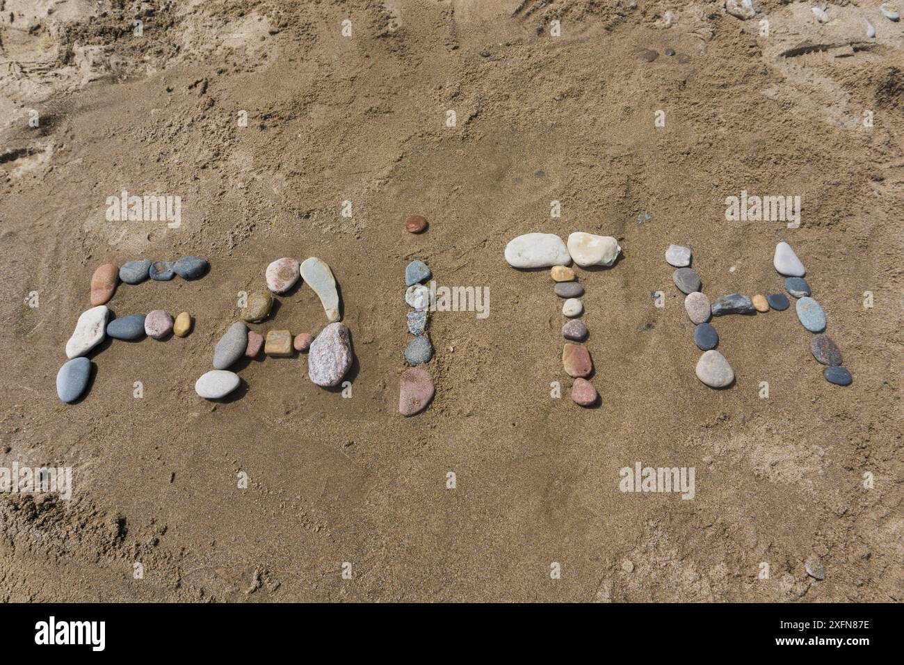 The word faith written in stones on the beach Stock Photo - Alamy