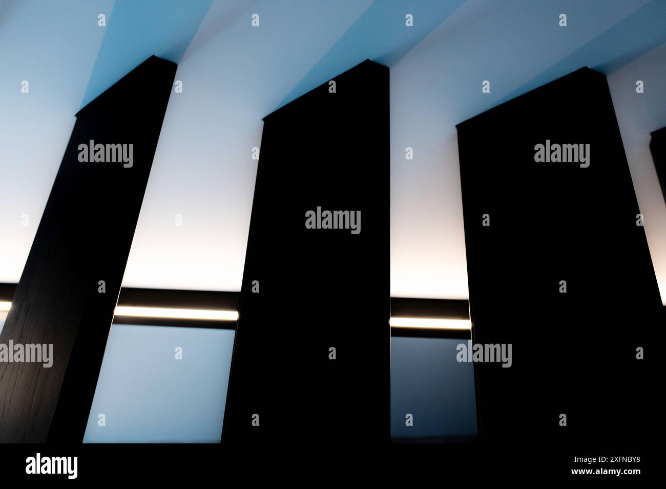 Light and shadows lines on the white and blue wall. Led line, the light ...