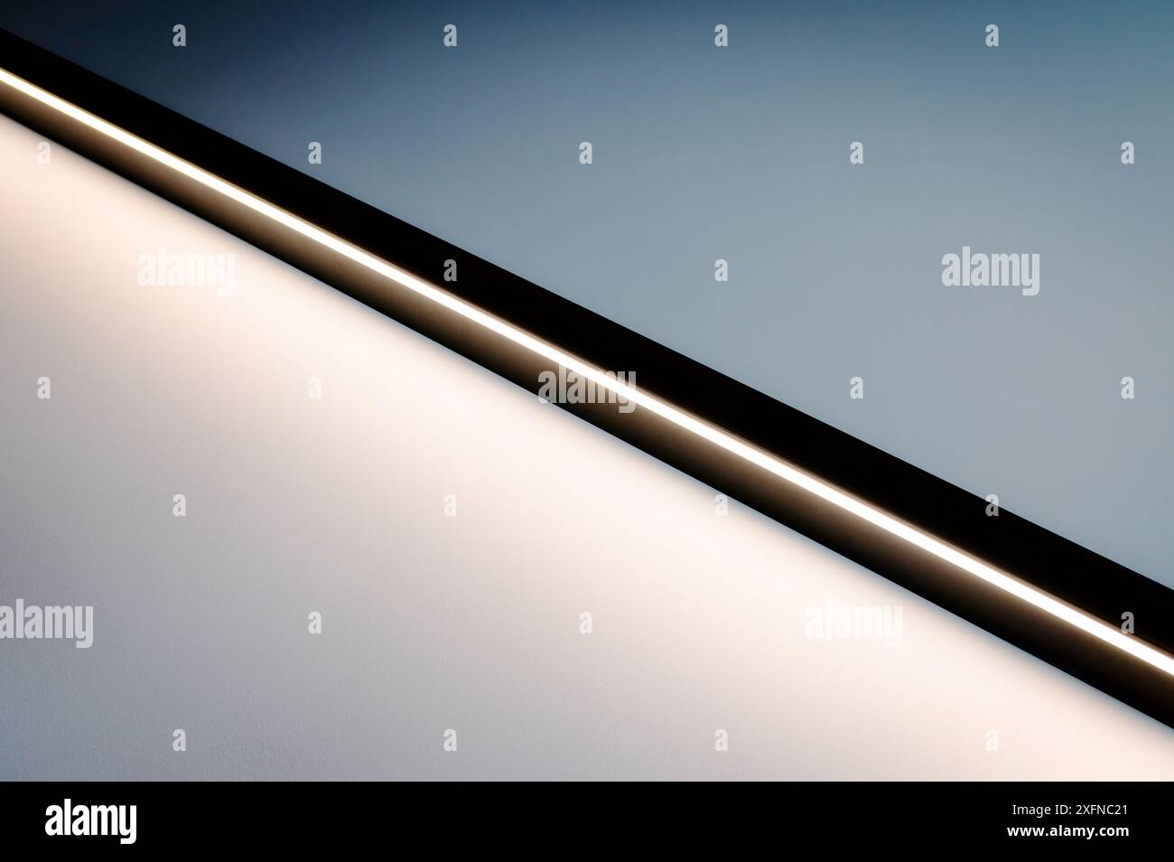 Light and shadows lines on the white and blue wall. Led line, the light ...