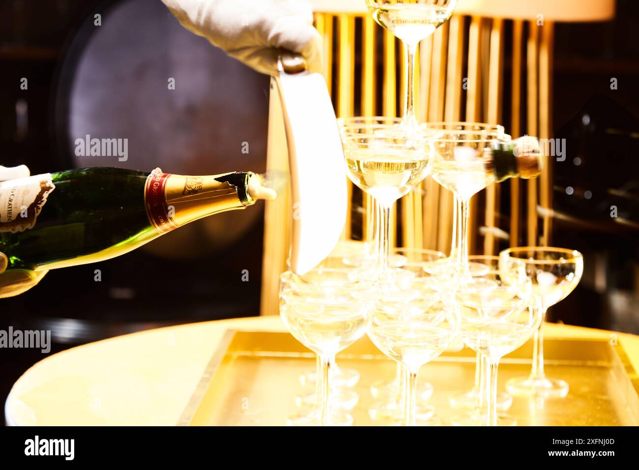 traditional sabrage ritual of a champagne bottle by a saber with a ...