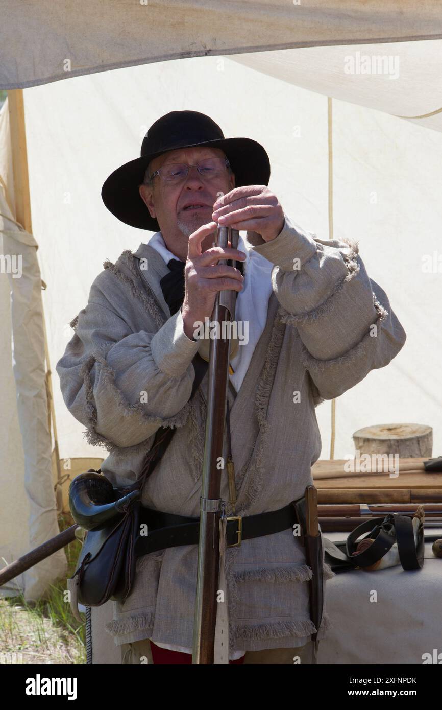 Reenactor explains the process of loading a musket (firearm carried by ...