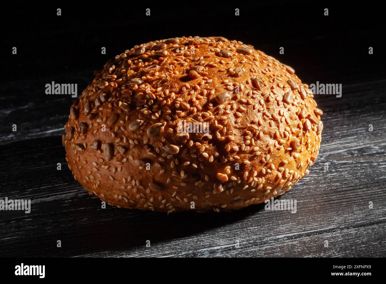 bread bun on black wood background Stock Photo - Alamy