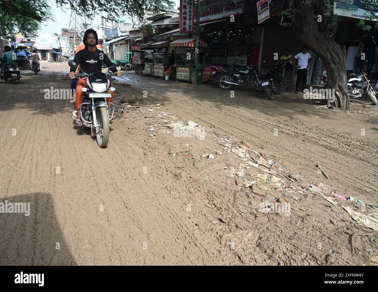 NEW DELHI, INDIA - JULY 4: Potholes and slush seen over Shani Bazaar ...