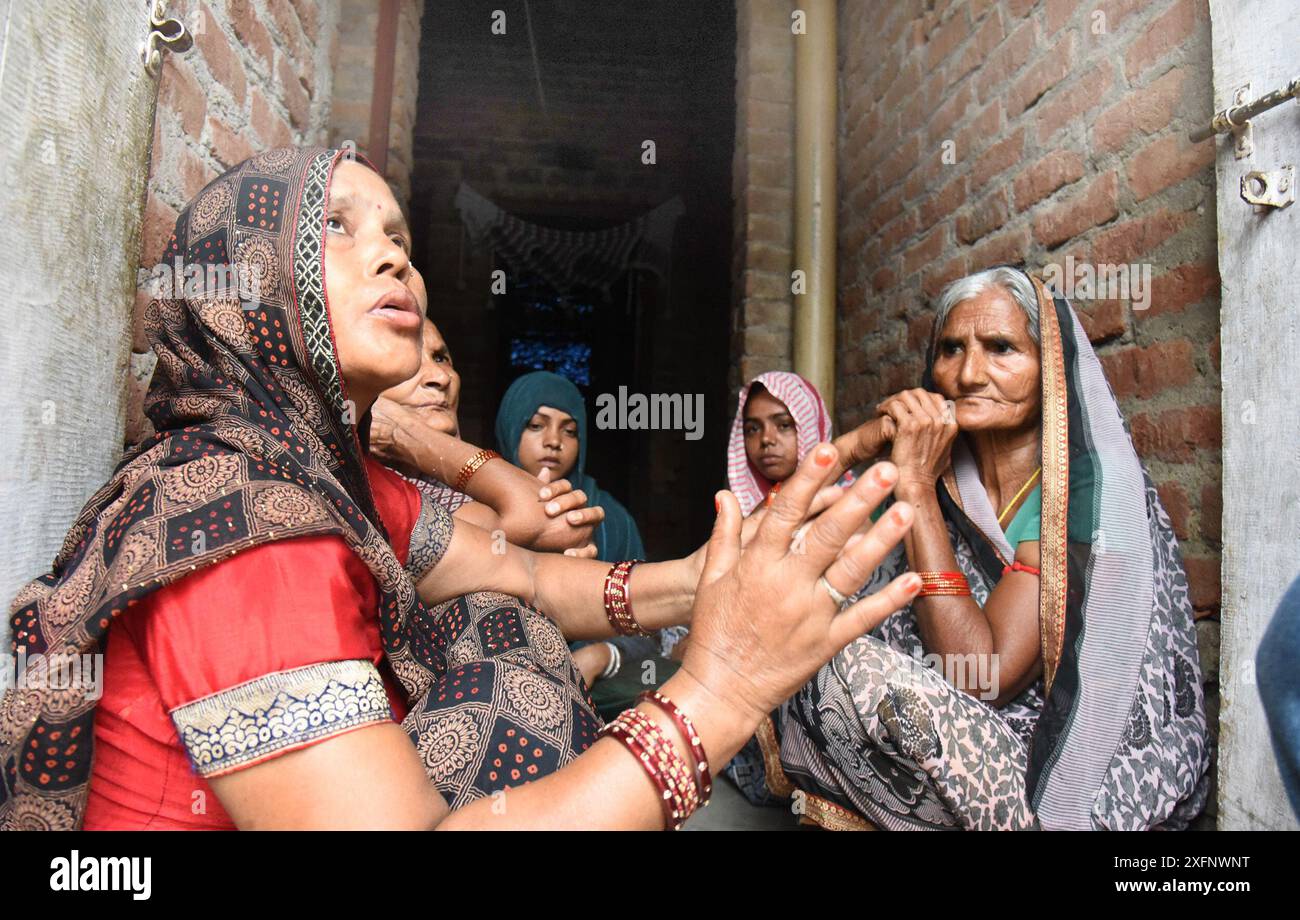 HATHRAS, INDIA - JULY 4: family members are saddened by the death of ...