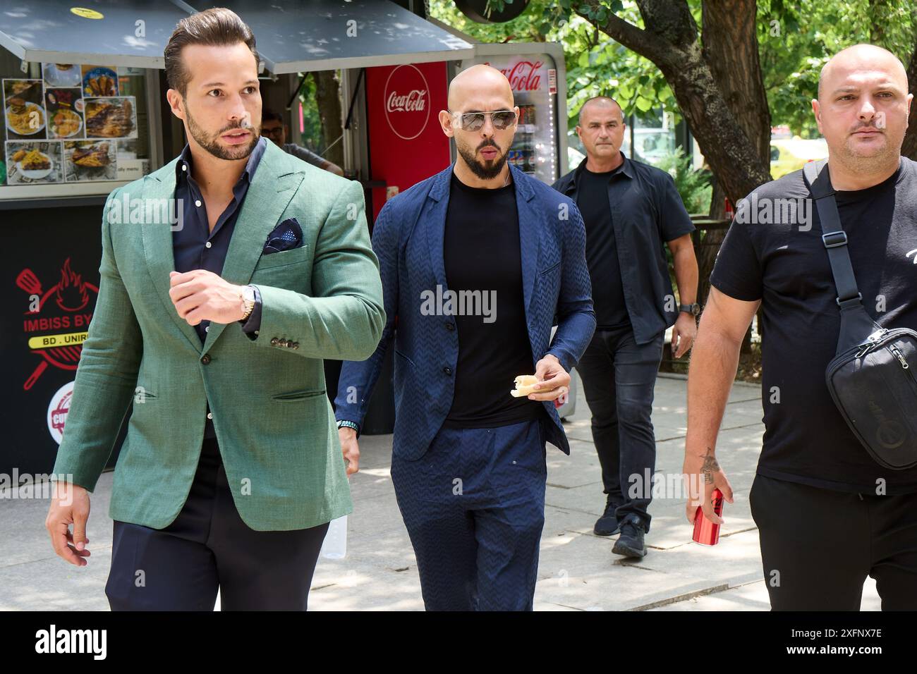 Bucharest, Romania. 4th July, 2024: Andrew Tate (C) and his brother Tristan Tate (L) return to ...