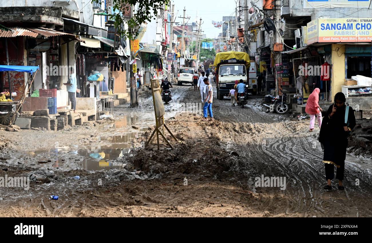 NEW DELHI, INDIA - JULY 4: Potholes and slush seen over Shani Bazaar ...