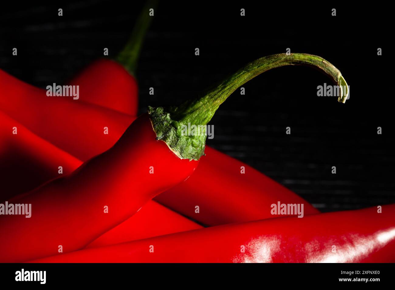long chili pepper on black background Stock Photo - Alamy