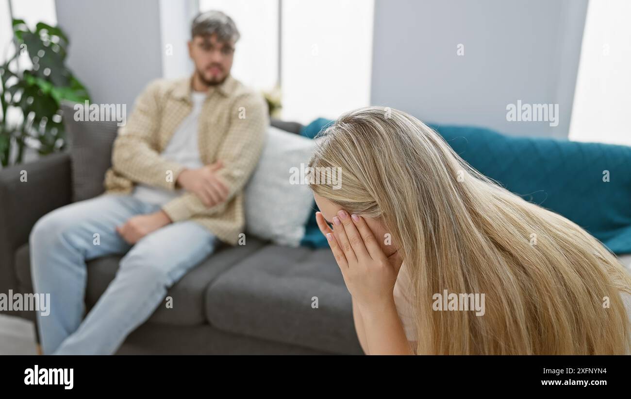 A distressed woman crying in the foreground with a concerned man ...
