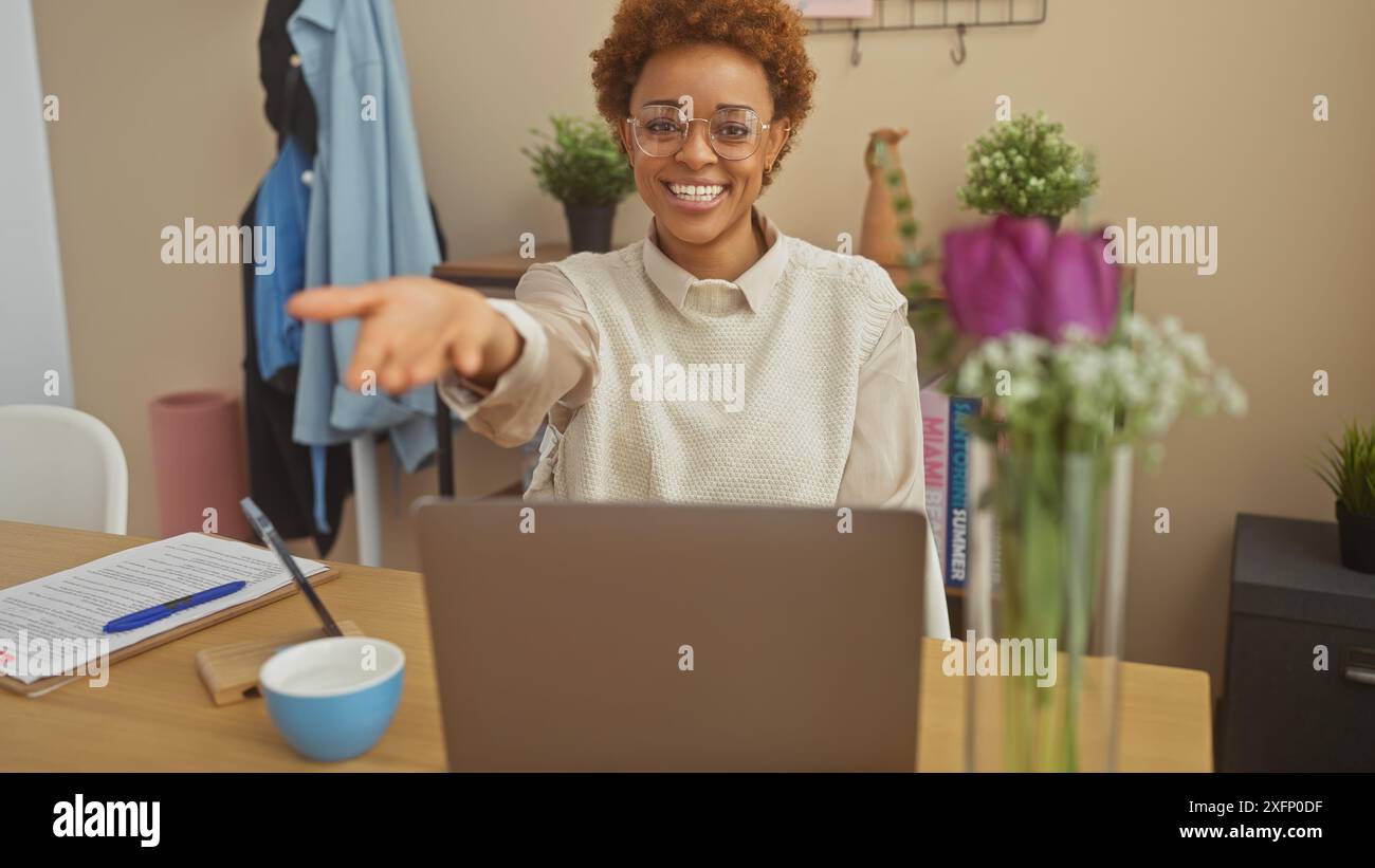 An african american woman extends her hand in a welcoming gesture ...