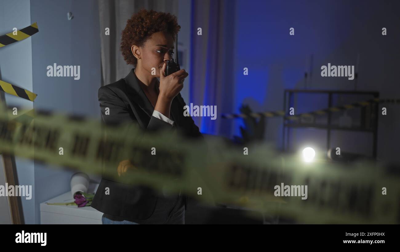African american woman detective investigates crime scene indoors at ...