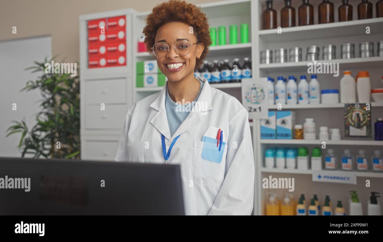 Smiling african american woman pharmacist wearing glasses stands in ...