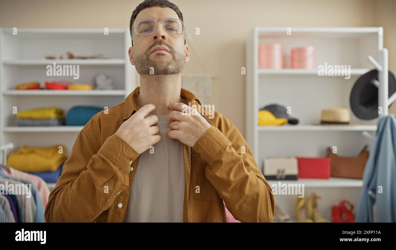 A stylish hispanic man adjusts his brown jacket in a bright modern ...