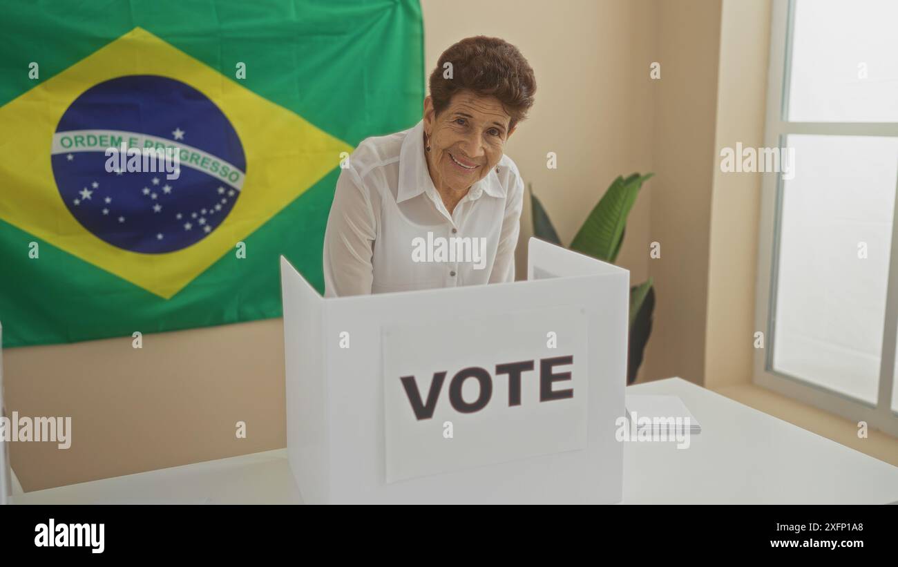 Elderly woman voting in a brazilian electoral room with a flag in the ...