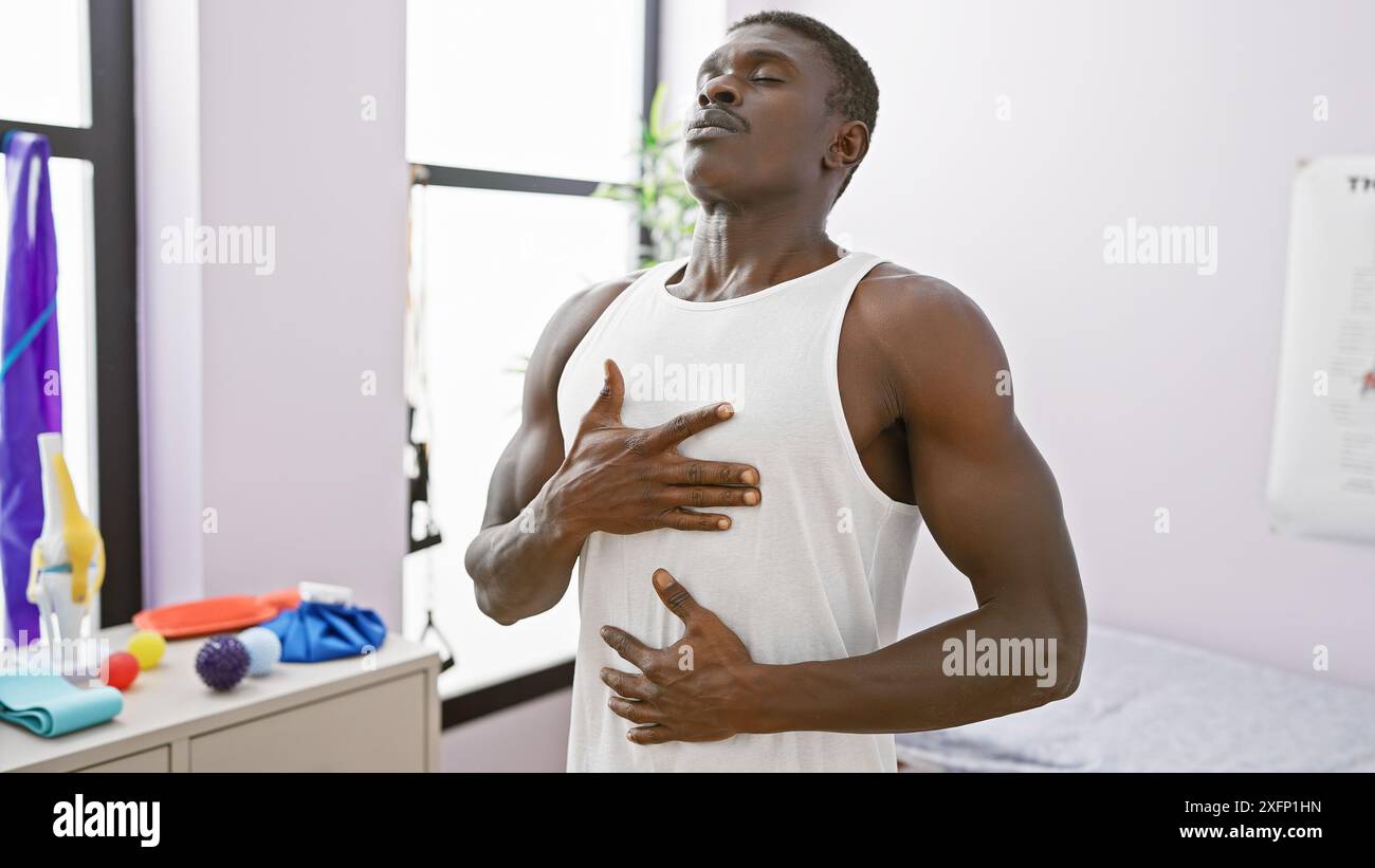 African american man breathing deeply in a rehab clinic room with ...