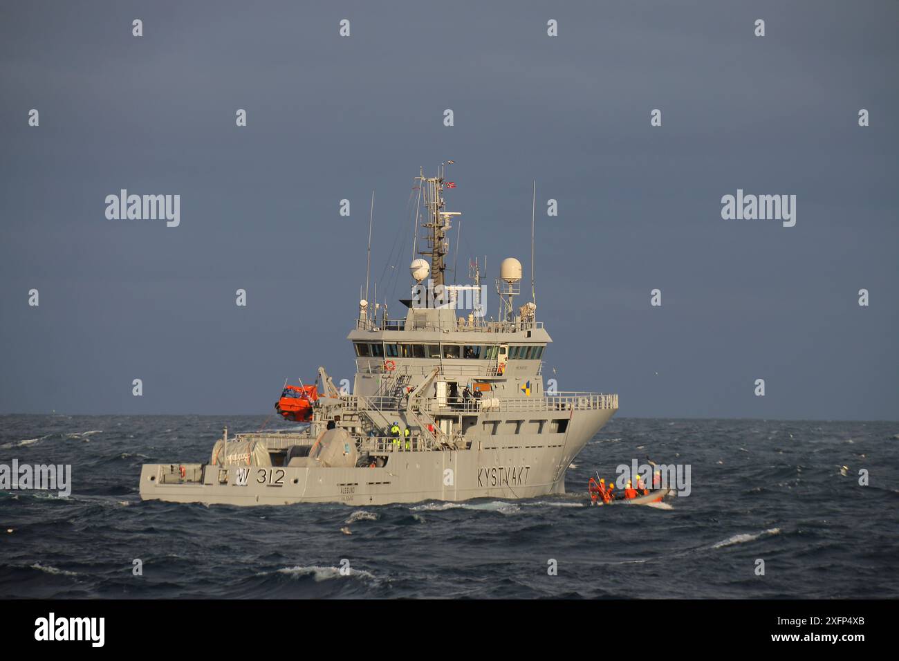 Norwegian coastguard vessel "Alesund" with boarding crew in rib ...
