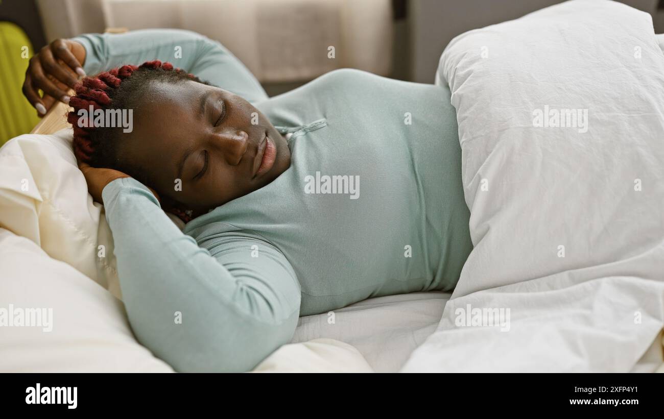 A calm african american woman with braids sleeps peacefully in a clinic ...