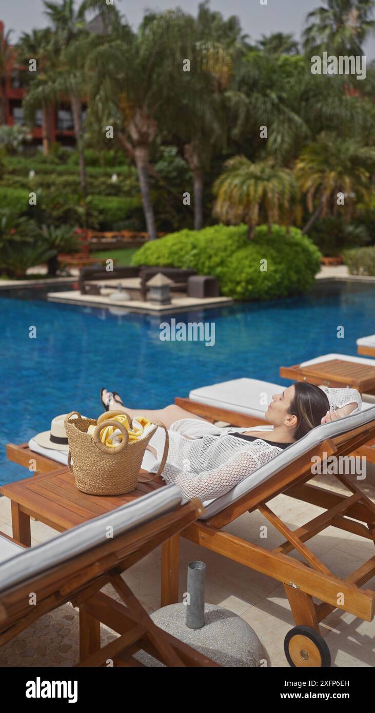 A relaxed woman enjoying the tranquil outdoor setting of a resort ...