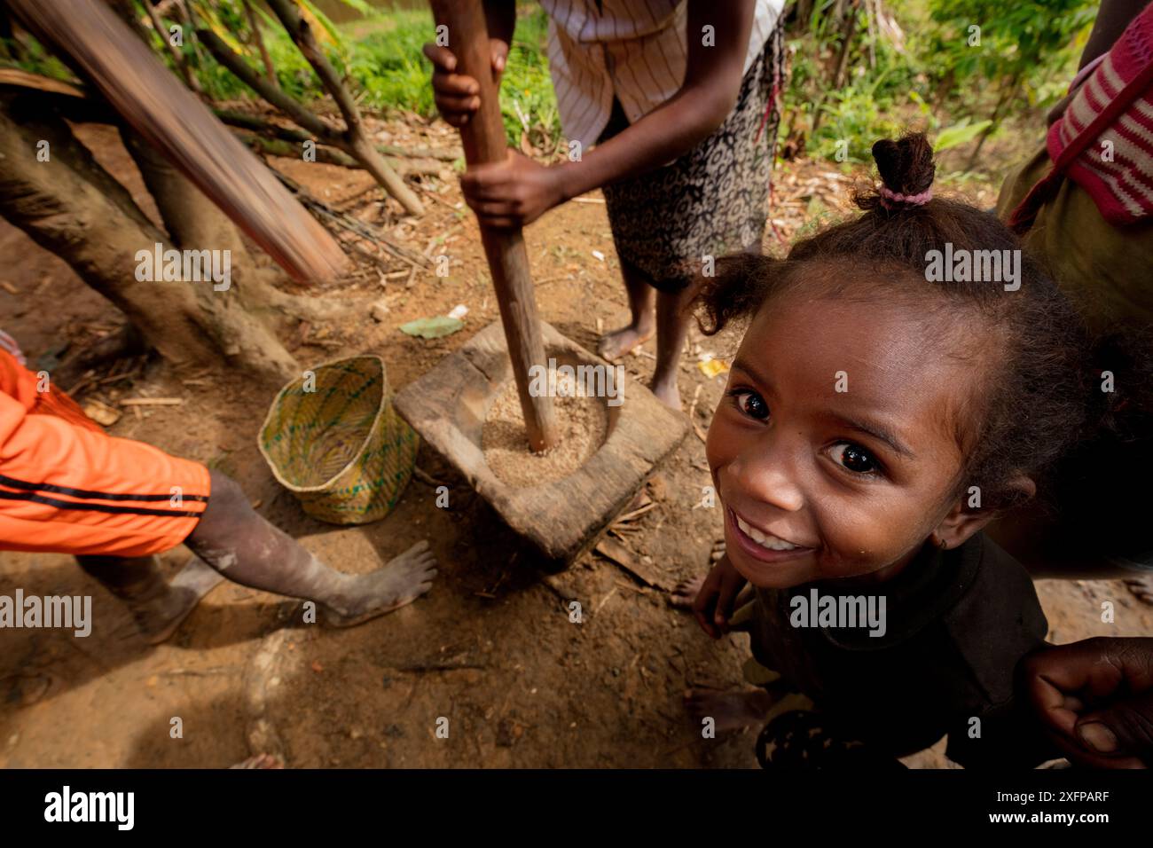 Local girl and her family was preparing rice. Andasibe-Mantadia ...