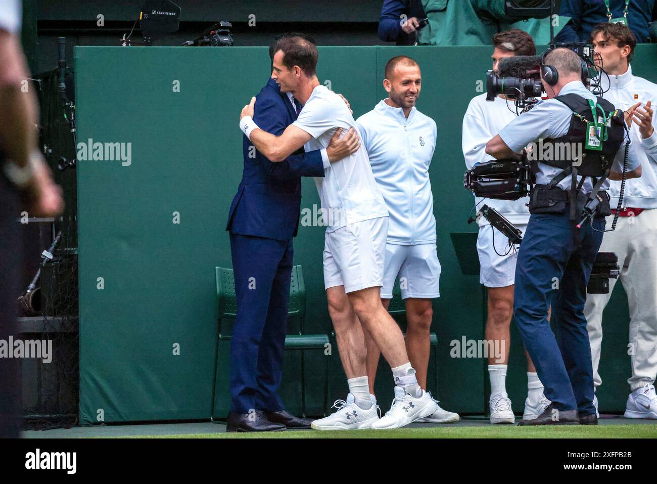 Wimbledon, London, UK. 04th July, 2024. Andy Murray receives a hug from ...