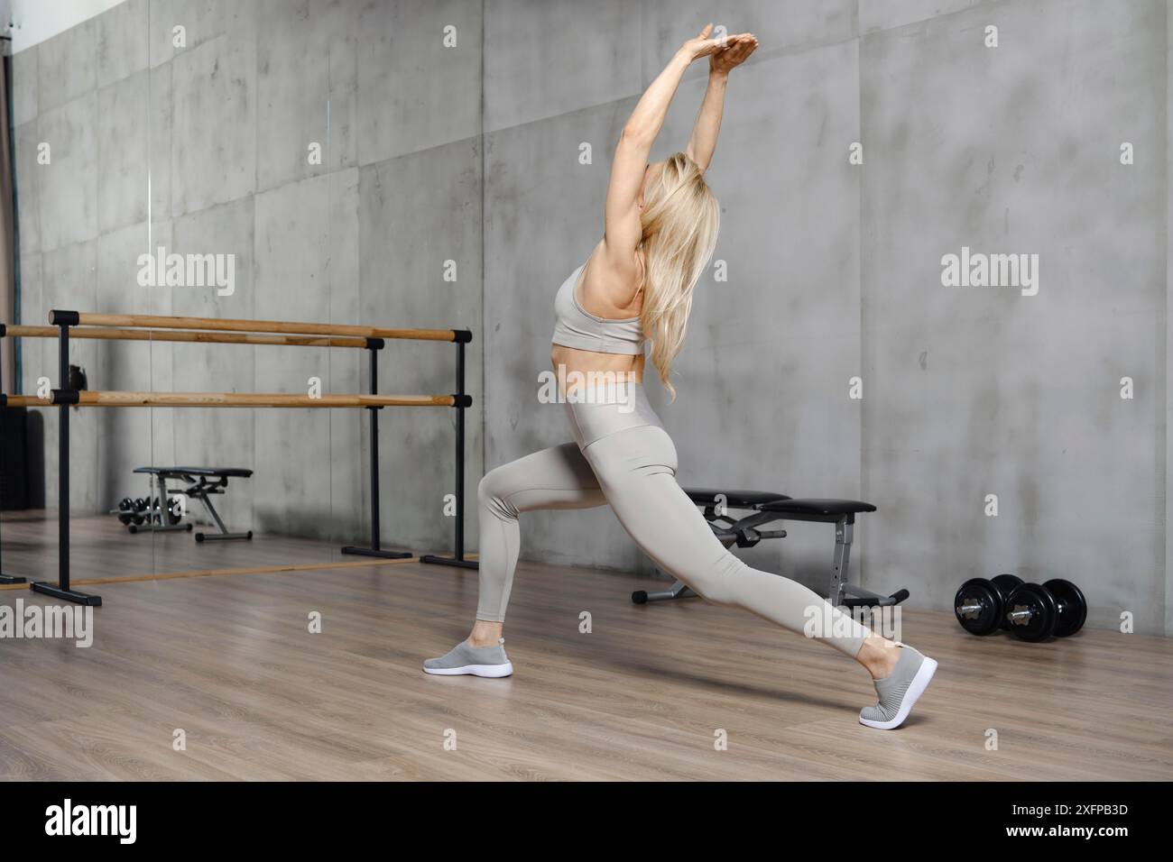 Rear side view of fitness woman bends backward stretching the muscles ...