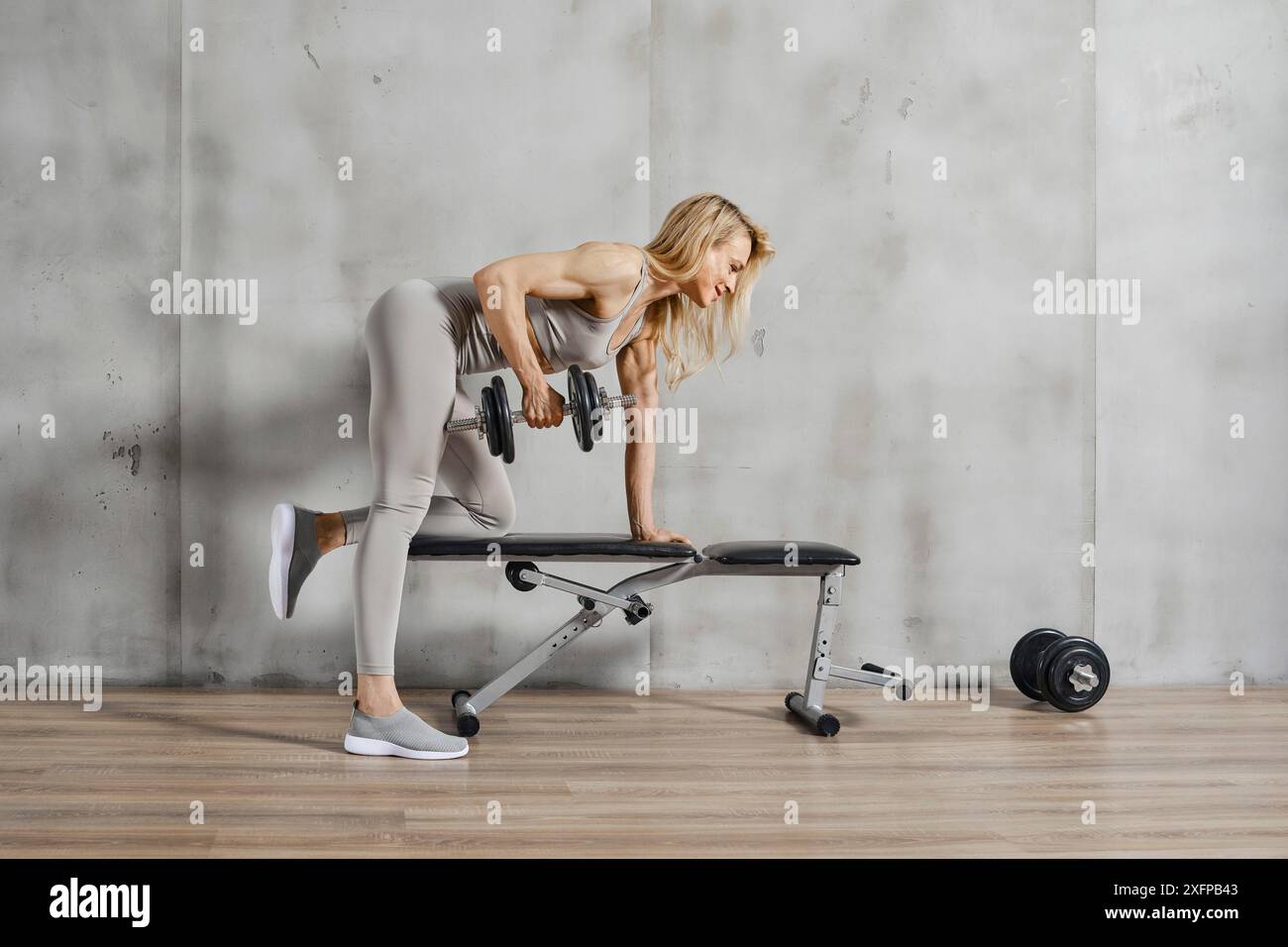Female bodybuilder do dumbbell pushup for wellness, performance and ...