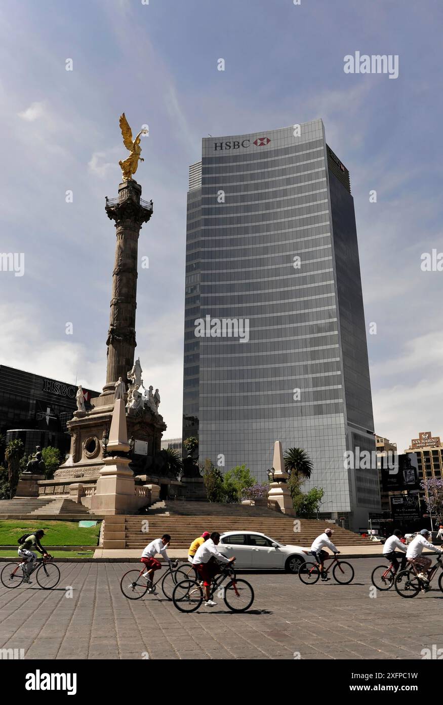 Mexico City, Mexico, Central America, Cyclists ride around a monument ...