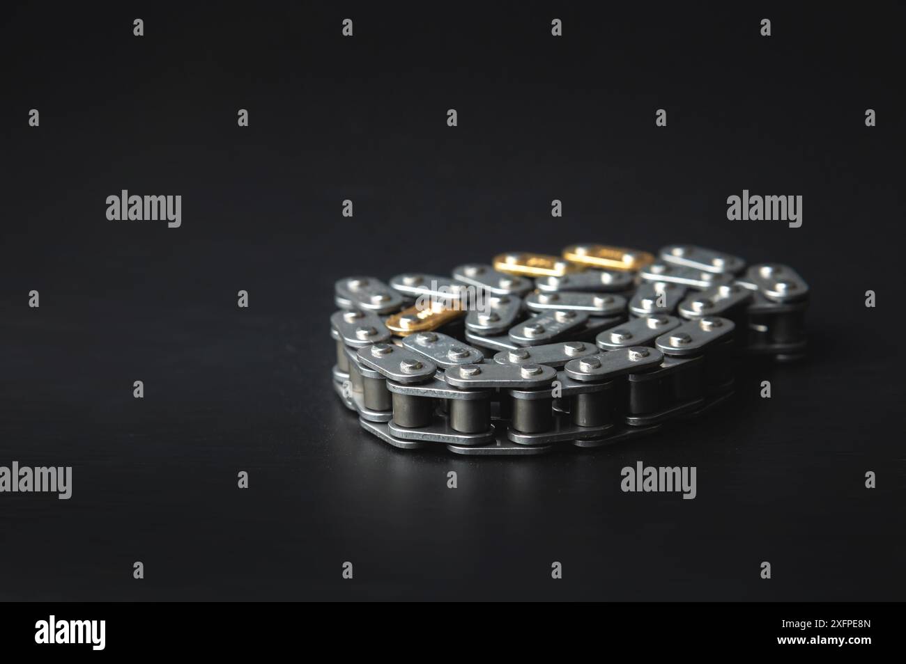 New timing chain on a black background close-up in selective focus ...