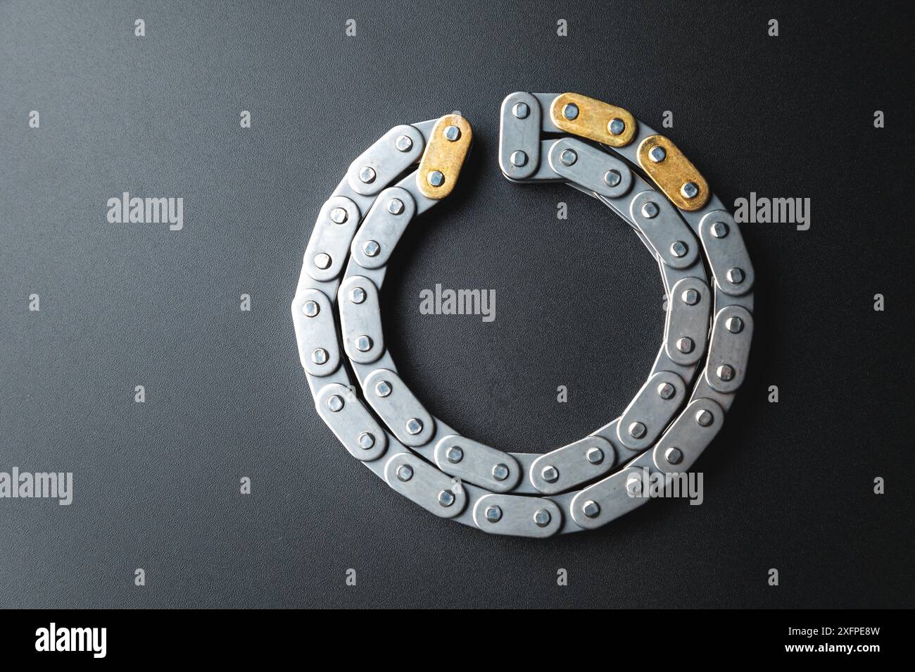 New timing chain on a black background close-up in selective focus ...