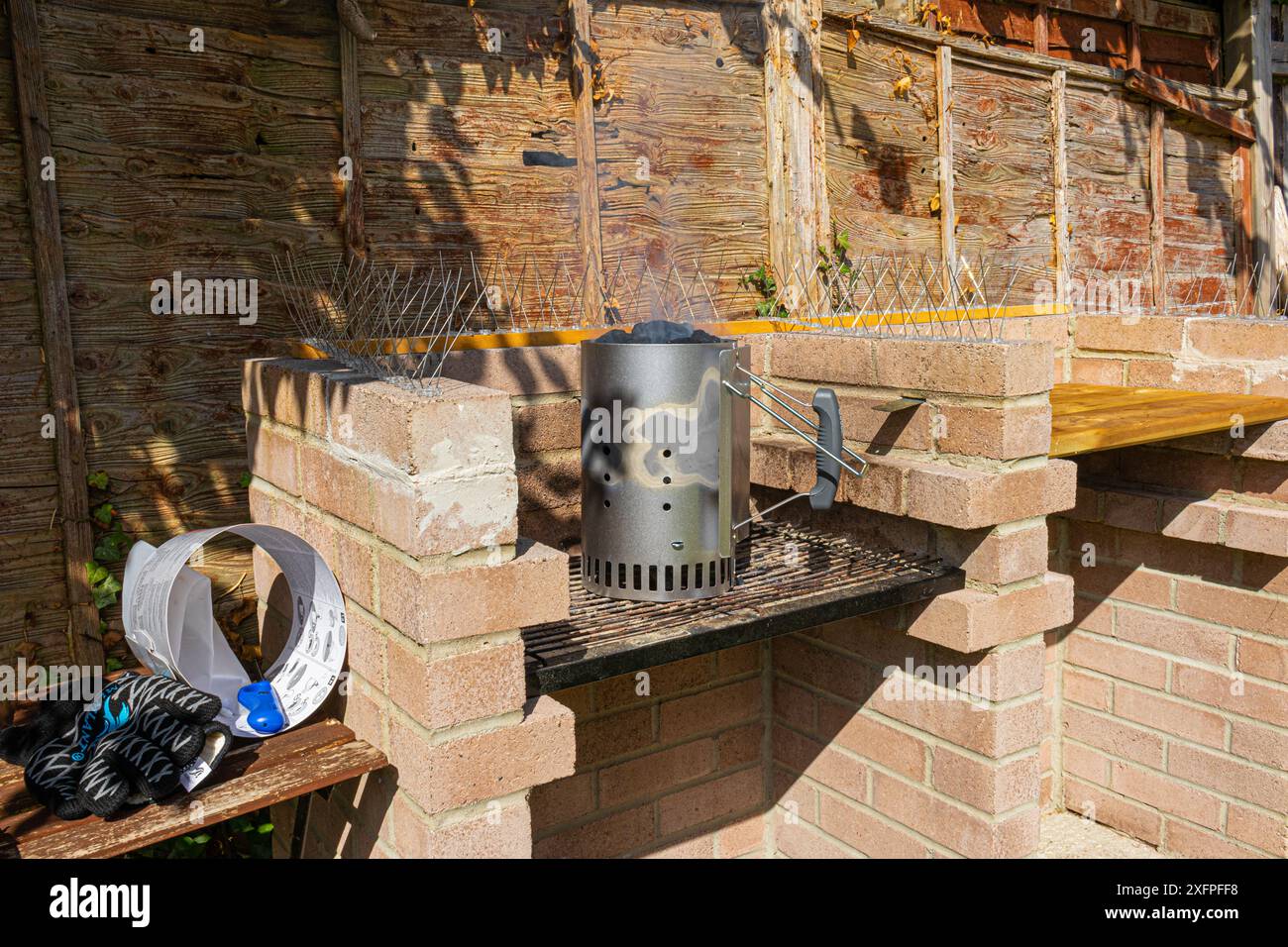 Preparing charcoal and briquettes in a bbq chimney starter - the ...