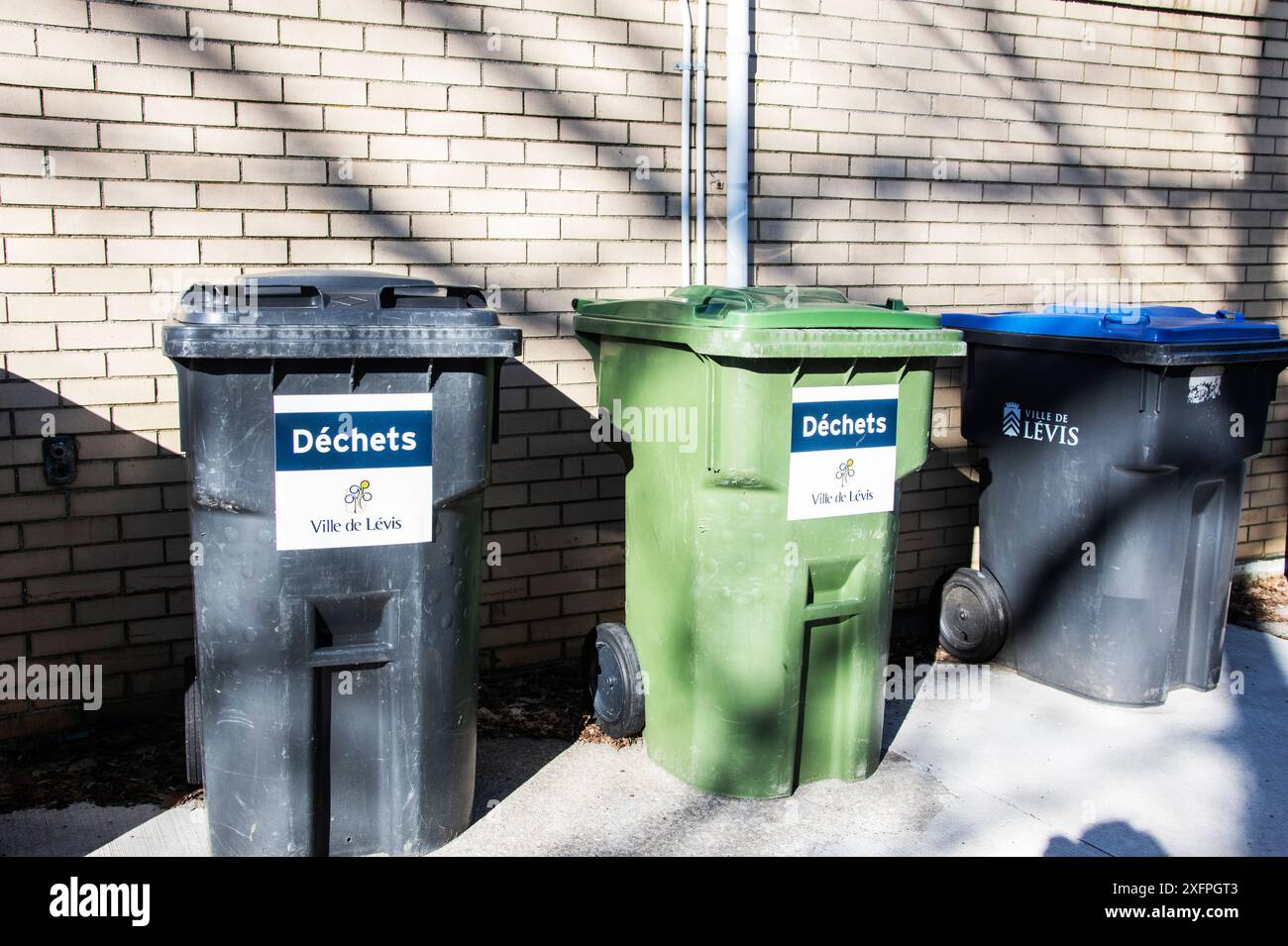 Wheelie garbage, recycling and organics bins at apartments on chem. du ...