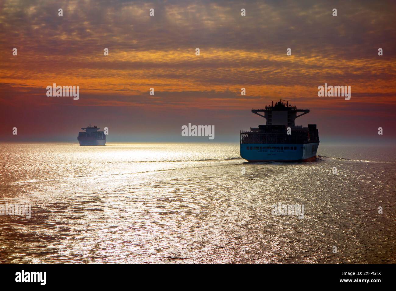 Cargo ship sailing sunset hi-res stock photography and images - Alamy