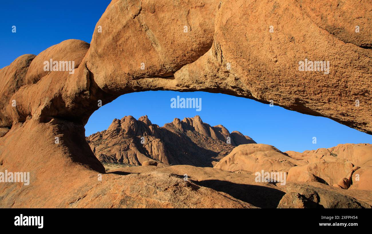 Rock Arch with the Spitzkoppe in the background Stock Photo - Alamy
