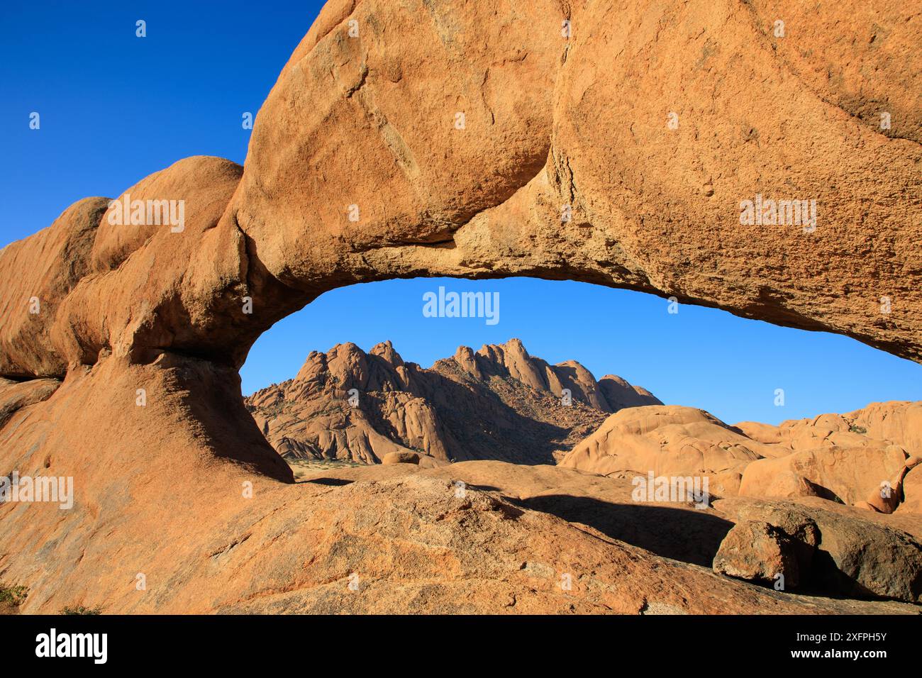 Rock Arch with the Spitzkoppe in the background Stock Photo - Alamy