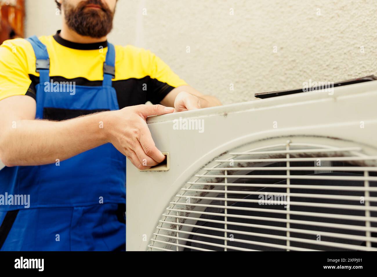 Knowleadgeable technician getting new external hvac system ready after ...