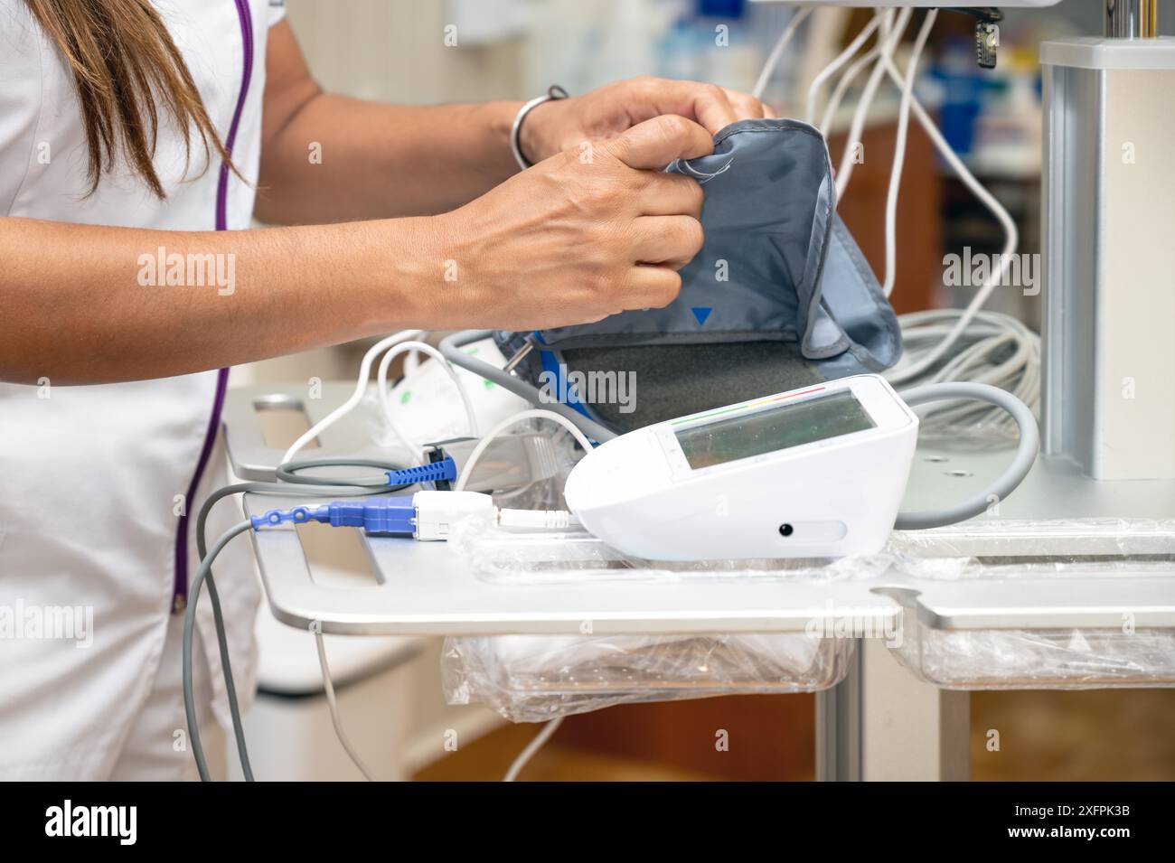Female nurse checking blood pressure of a senior woman. High quality ...