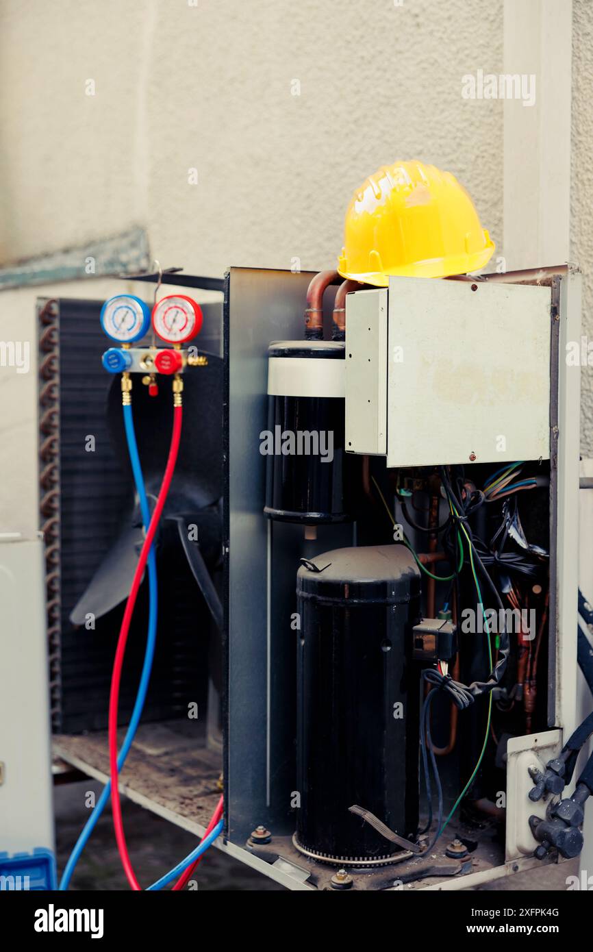 Close up of damaged external opened out of service air conditioner unit ...
