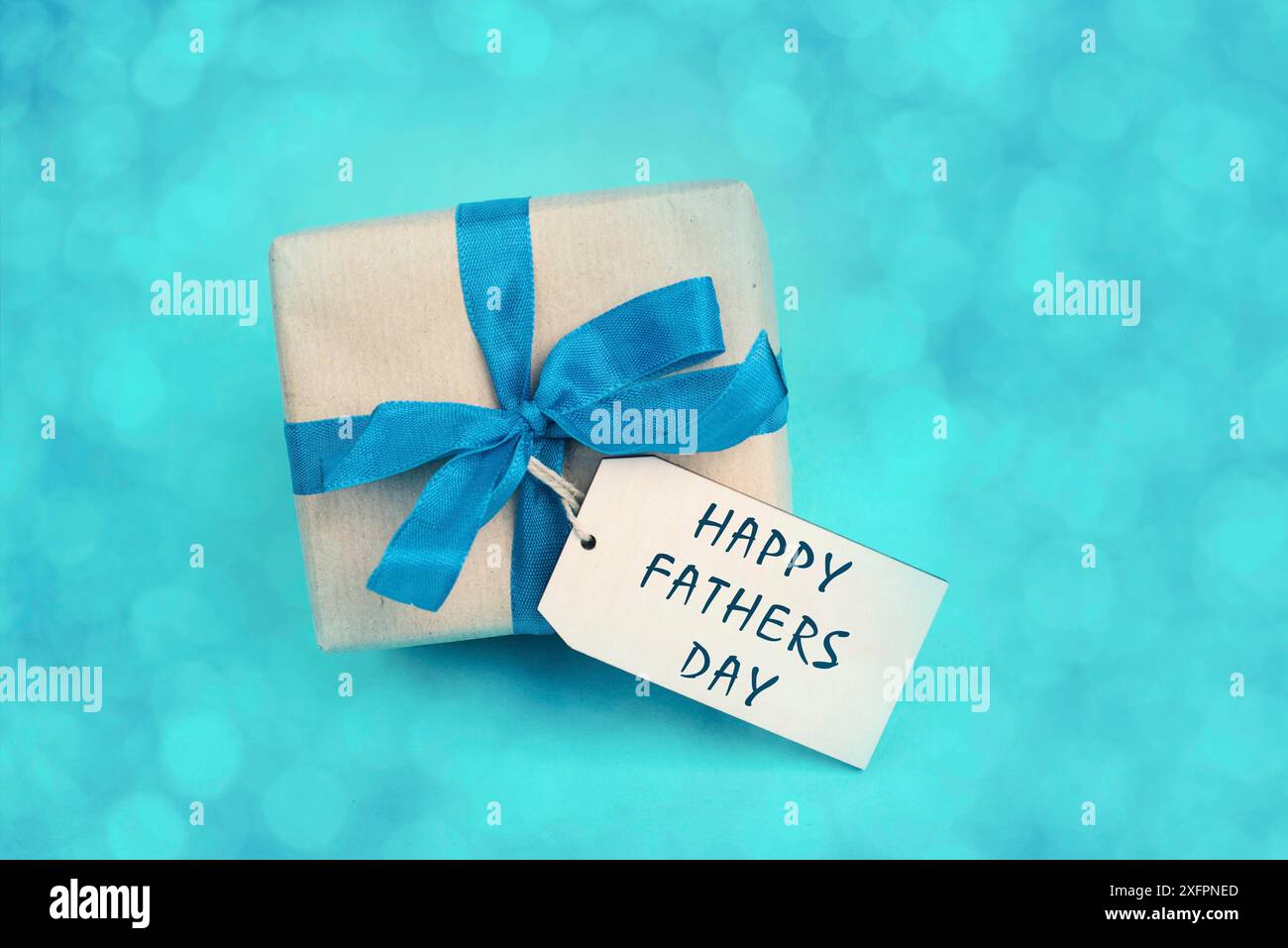 Gift box with ribbon and bow for fathers day, blue bokeh light ...