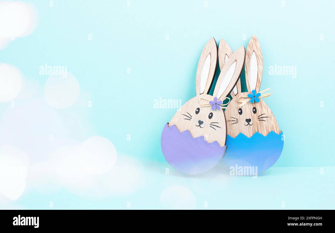 Easter bunny or rabbit couple cuddle together, wooden egg, spring ...