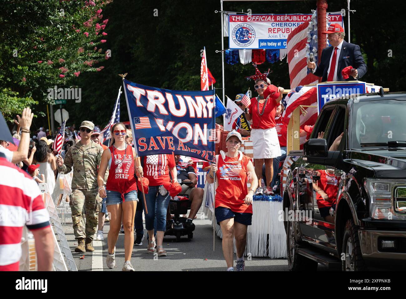 Woodstock, Georgia, USA. 4th July, 2024. Donald Trump supporters march ...
