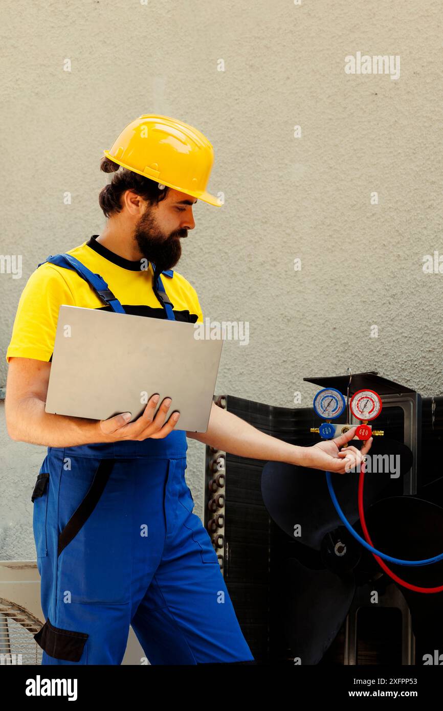 Smiling competent mechanic calibrating pressure measurement device ...