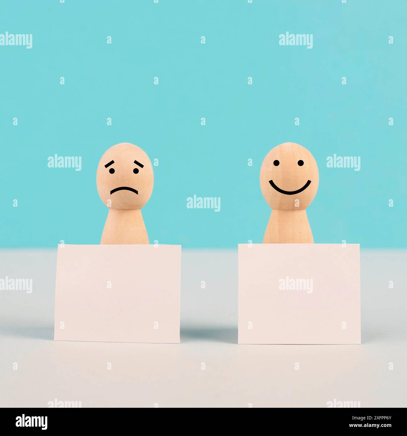 Man with a sad and a happy face holding empty signs, positive and ...